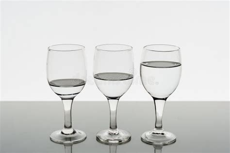 Three Wine Glasses Filled With Water Reflected On The Table Stock Image Image Of Luxury