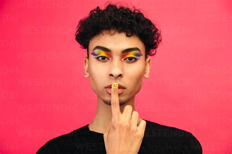 Gay Man Wearing Rainbow Colored Eye Shadow And Smiley Face Fingernail