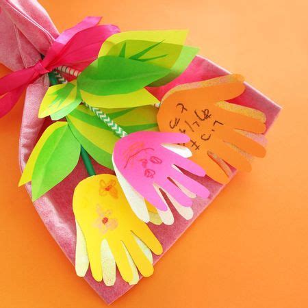 A Pink Paper Bag With Handprinted Flowers On It