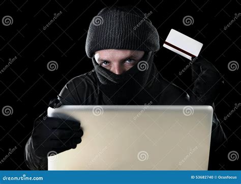 Man In Black Holding Credit Card Using Computer Laptop For Criminal