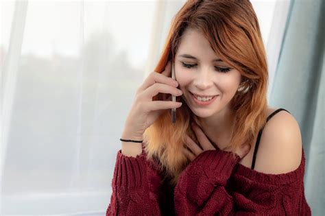 Wanita Muda Di Rumah Menggunakan Smartphone Untuk Membuat Panggilan Foto Stok Unduh Gambar