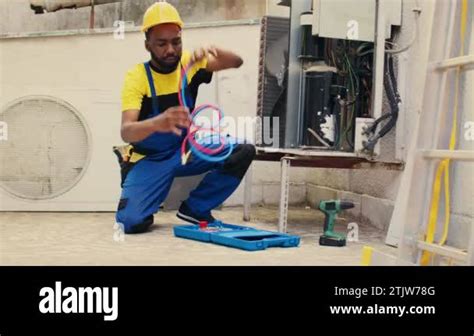 Skillful African American Worker Doing Routine Condenser Maintenance