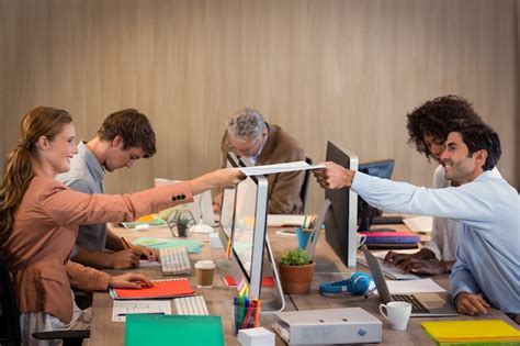 Premium Photo Businessman Passing A File To His Colleague
