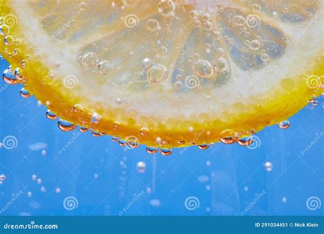 Curved Edged Macro Shot Of See Through Lemon Slice On Blue Background