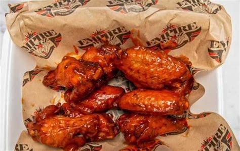 Saucy Buffalo Wings On Branded Takeout Paper