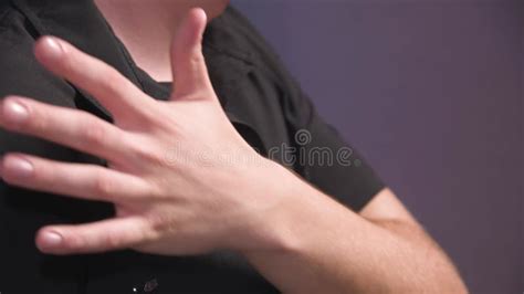 A Young Caucasian Male In A Medical Uniform Self Massage His Chest