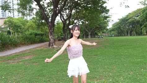Asian Girl Dancing And Cheering Moving Her Arms Inside The Park During The Day 52587014 Stock