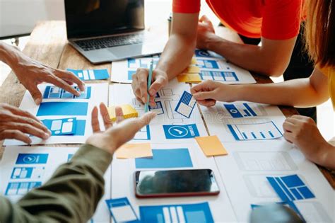 Ux Developer And Ui Designer Brainstorming About Mobile App Interface