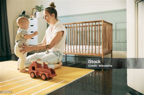 아기 어머니 및 집에서 걷는 법을 배우고 교육 또는 성장 유대감과 놀이 발달 보살핌 및 엄마는 아이 또는 신생아의 첫 단계를 가르치고 집 보육원에서 균형 또는 지원을