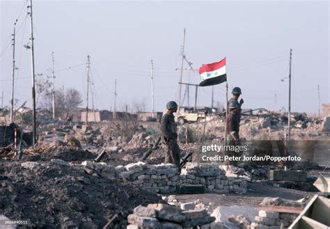 Iraqi Troops Hoisting Their Flag After Retaking The Village Of El