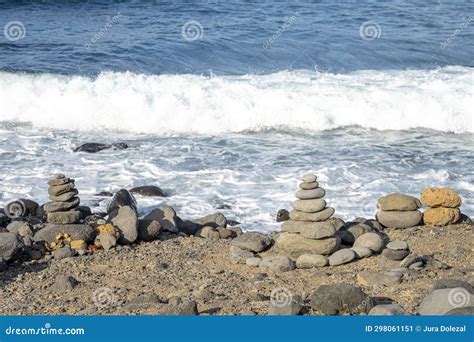 A Stony Beach In Summer With A Nice Sky And Many Tourist Mounds