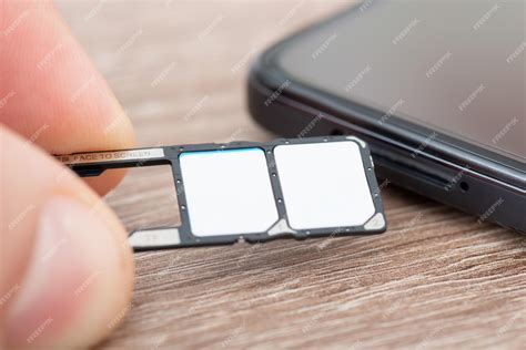 Premium Photo Inserting Two Sim Cards Of Different Operators In Order