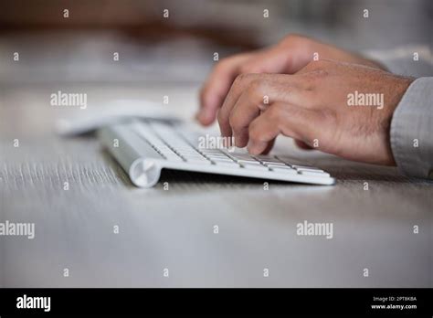 Typing In A Clients Details An Unrecognisable Businessman Typing On His Keyboard In The Office