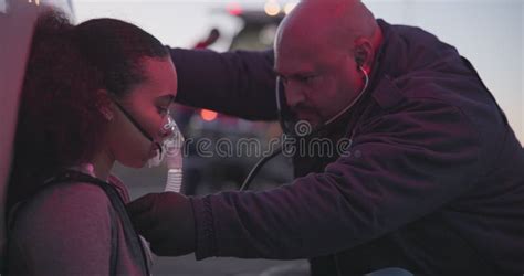 Paramedic Woman And Oxygen Mask In Road For Accident Crime Scene Or