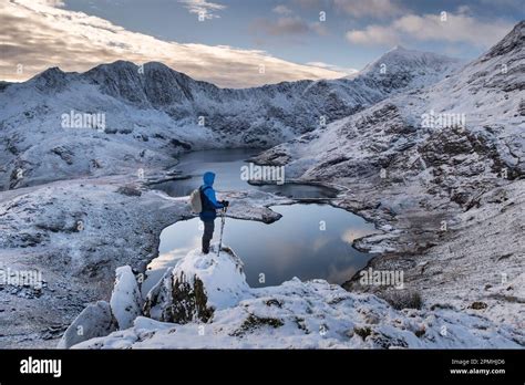 Walker Looking Out Over Mount Snowdon Yr Wyddfa Y Lliwedd And Llyn Llydaw In Winter Snowdon