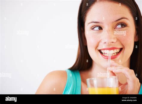 Shes Happy With Her Orange Juice An Attractive Young Woman Looking