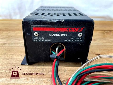 An Electronic Device Is Sitting On Top Of A Wooden Table With Wires Attached To It