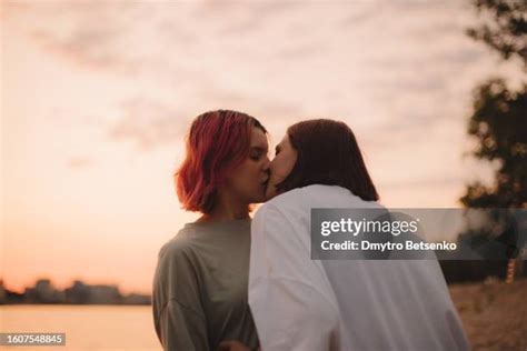 147 Young Romantic Lesbian Couple Kissing At Sunset On Seaside Stock
