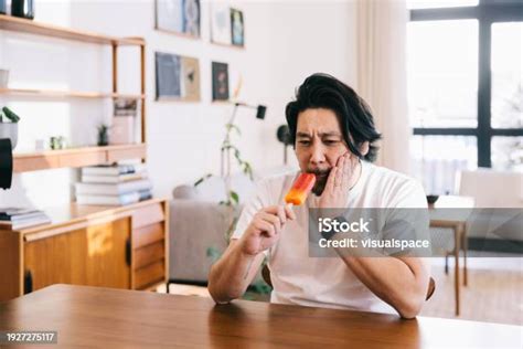 Japanese Man Winces As He Encounters A Toothache From Biting Into An