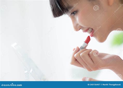 Beautiful Young Asian Woman Applying Lipstick Red On Mouth Beauty Girl