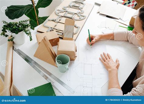 Female Designer Drawing Schematics Behind A Table Stock Photo Image Of Master Creative