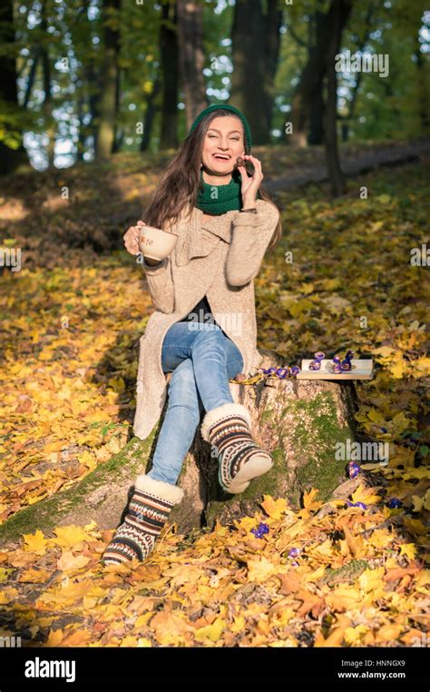 Girl Sitting On Tree Stump Stock Photo Alamy