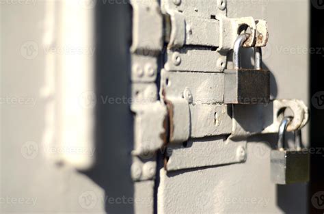 A Photograph Of The Fragment Is A Metal Door With Two Square Padlocks