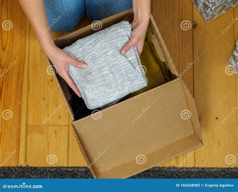 Girl Puts Clothes From A Rack In A Cardboard Box Stock Image Image Of Movement Donates 166558985