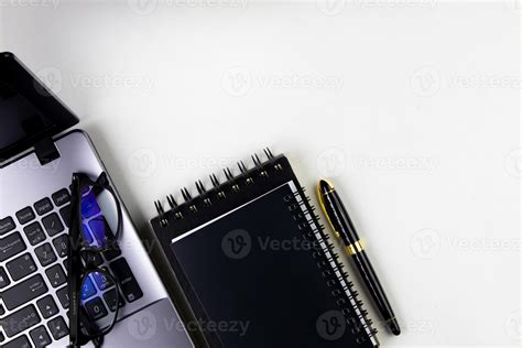 Top View Of Modern White Office Desk With Computer Keyboard Blank Notebook Page And Other