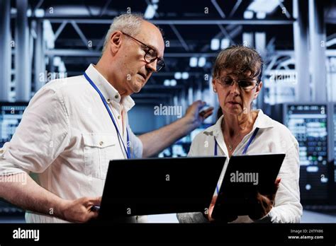 Computer Scientists Performing Diagnostic Assessments On Server Rigs To