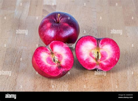Red Fleshed Apples On Table One Sliced To Show Colour Of Red Flesh