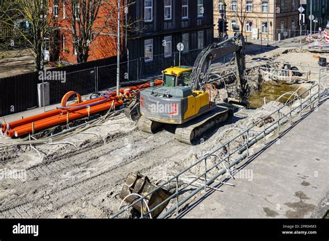 Underground Pipeline Replacement Site With Dewatering System On City Street Excavator Digs Deep
