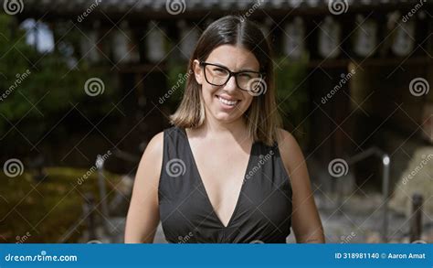 Cheerful Beautiful Hispanic Woman Proudly Posing With Her Glasses On