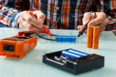 Electrician Measuring Battery Voltage With A Multimeter Hom Colourbox