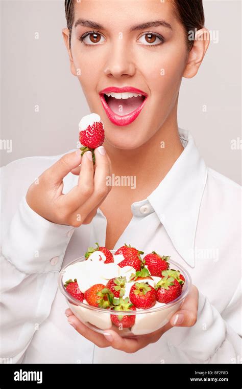 Portrait Of A Woman Eating Strawberries In Cream Stock Photo Alamy