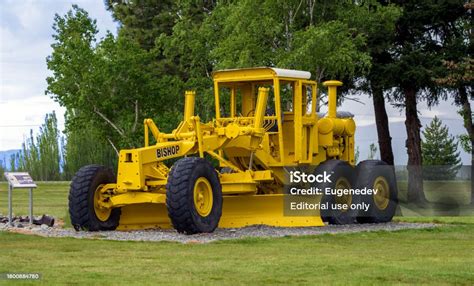 A Vintage Yellow Grader With Bishop Printed On Its Side Displayed