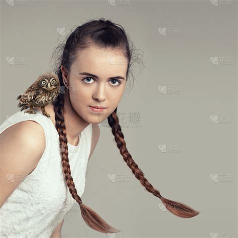 女学生女孩的肖像，梳着辫子，肩上有小猫头鹰