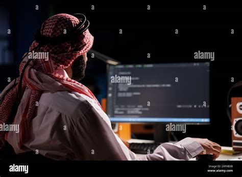 Arab Software Developer Typing Code And Focused On Running Algorithms