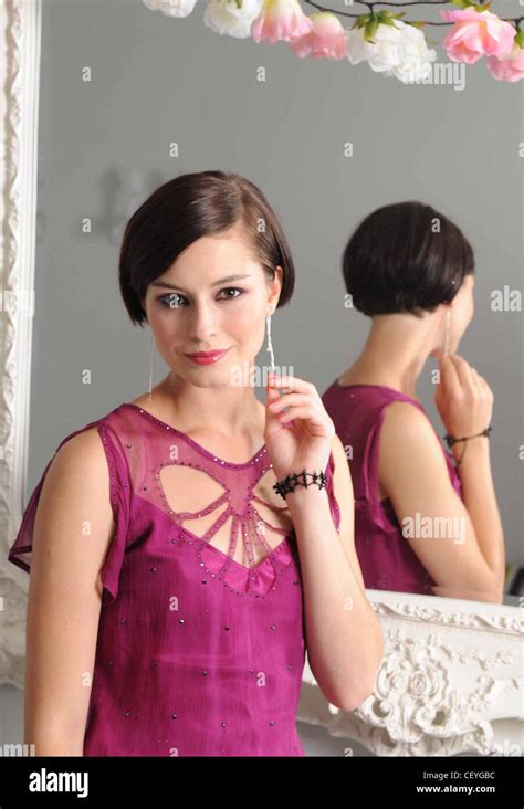 Female Short Brunette Hair Wearing A Mauve Top Cut Out Chest Detail