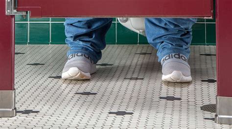 Men In Bathroom Stall