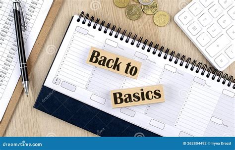 Back To Basics Word Written On Wooden Block On Planner With Coins