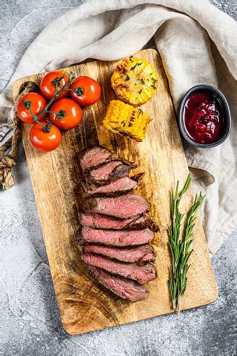 나무 도마위에 얇게 구운 필레 미뇽 스테이크 쇠고기 안심 회색 배경입니다 맨 위 보기 검은색에 대한 스톡 사진 및 기타 이미지