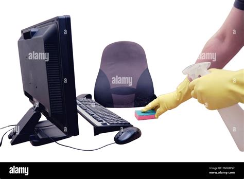 cleaning the office a janitor in yellow gloves wipes tables and computer equipment with a rag