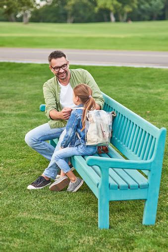 행복한 젊은 아버지와 그의 어린 딸이 벤치에 앉아 따뜻한 날에 녹색 공원에서 함께 시간을 보내는 전체 길이샷 2명에 대한 스톡 사진 및 기타 이미지 Istock