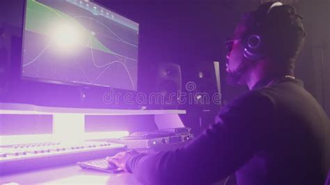 Soundman Working On Music Track Using Computer In Audio Studio Stock