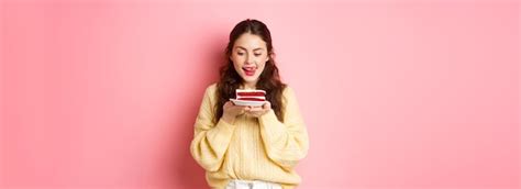 Premium Photo Young Slim Girl Lick Her Lips From Temptation Looking At Delicious Piece Of Cake