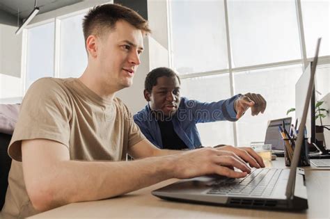 Two Programmers Working In The Office Of A Software Development Company