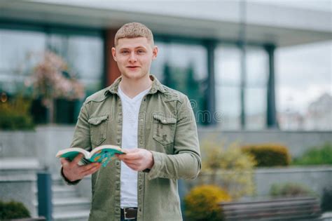 The Book Nerd A Male Book Lover Sitting Outdoors With Book In Hand Stock Image Image Of