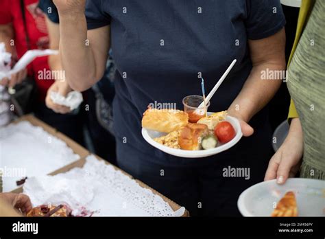 Food In Plate In Your Hand Man Eating On Street Delicious Food Queue