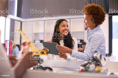 Stem 기술 수업에서 십대 소녀를 돕는 디지털 태블릿을 가진 여성 고등학교 교사 14 15 살에 대한 스톡 사진 및 기타 이미지 14 15 살 2명 30 34세